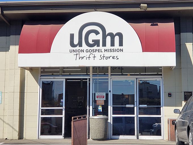 That red awning means business! UGM's clean, modern entrance promises an organized treasure hunt without the usual thrift store chaos.