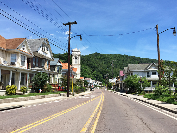 Mountain backdrop frames this small town like nature's own picture-perfect postcard from simpler times.