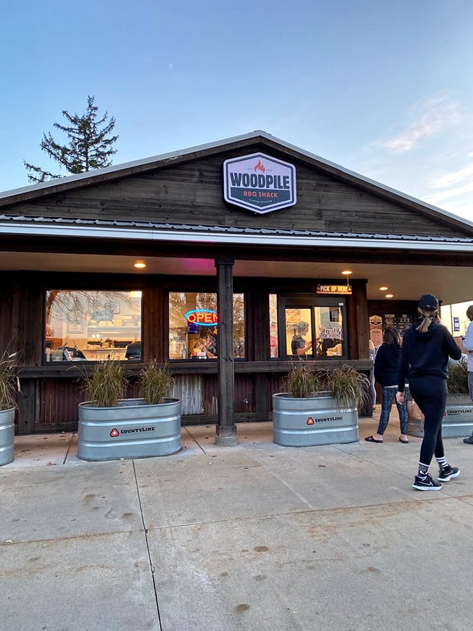 Rustic wood siding and welcoming lights create the perfect atmosphere for serious barbecue conversations and even better food.