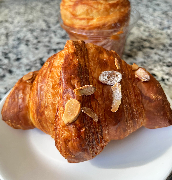 This almond croissant isn't just breakfast&mdash;it's a masterclass in flaky, buttery perfection. Those toasted almonds on top are like jewelry for your pastry.