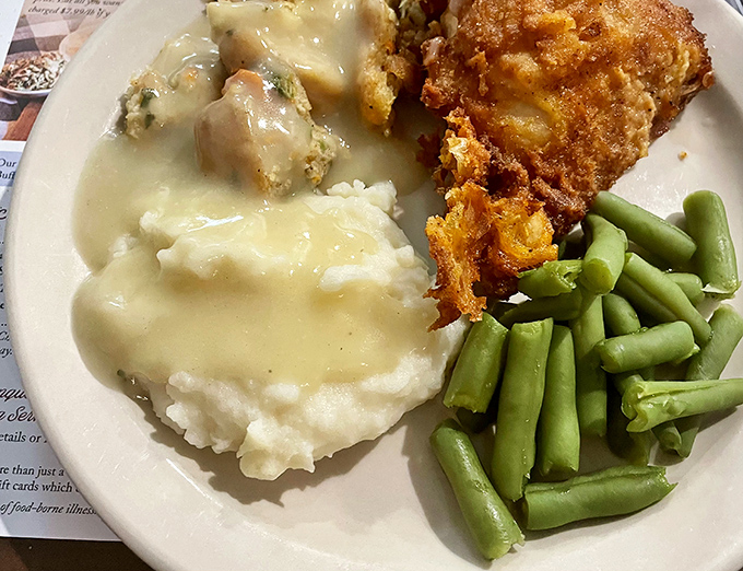 This plate tells the whole story&mdash;golden fried chicken, cloud-like mashed potatoes swimming in gravy, and green beans that haven't forgotten their garden roots.