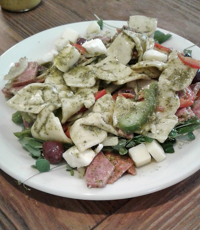 The antipasto salad arrives like an edible mosaic &ndash; meats, cheeses, and vegetables arranged with the care of an artist's final brushstrokes.