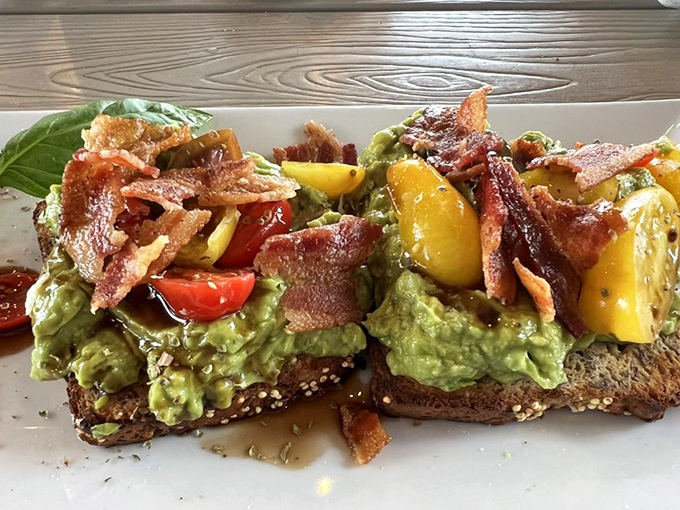 Avocado toast that would make millennials weep with joy&mdash;crispy bacon, vibrant tomatoes, and that perfect green spread on artisanal bread.