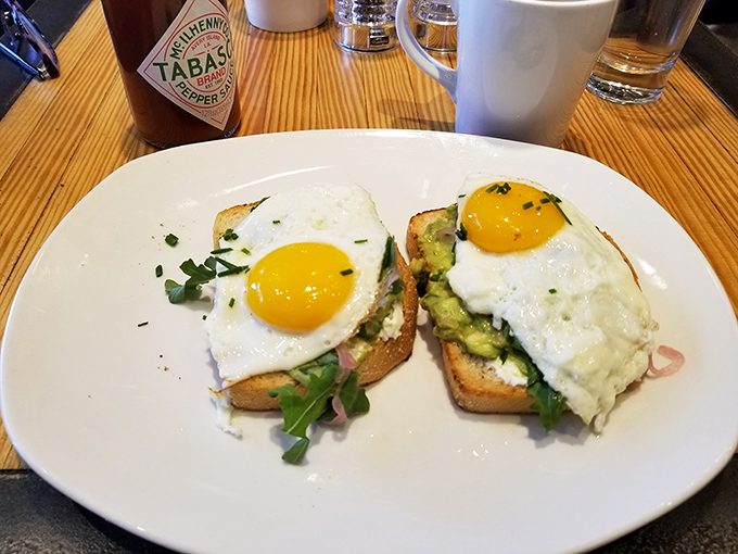 Avocado toast gets the smokehouse treatment with sunny-side-up eggs that stare back at you saying, "Go ahead, pierce my golden heart."