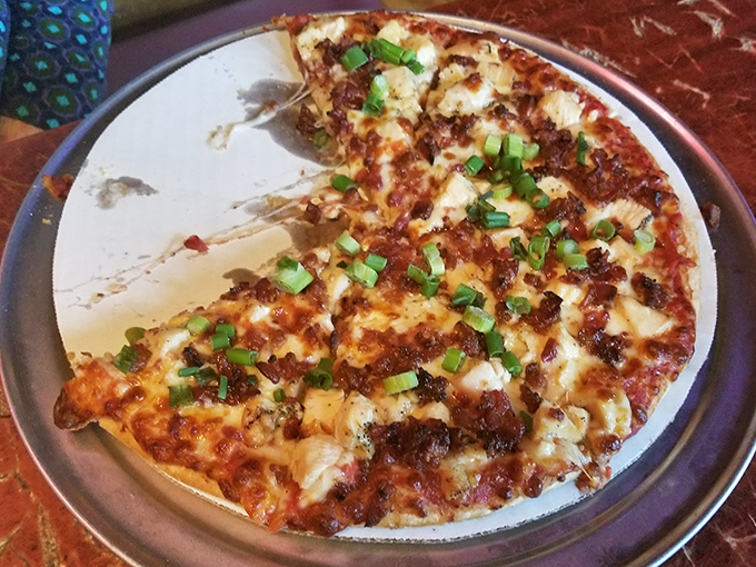 This BBQ chicken pizza, topped with fresh green onions, proves that sometimes the best traditions are the ones we invent ourselves.
