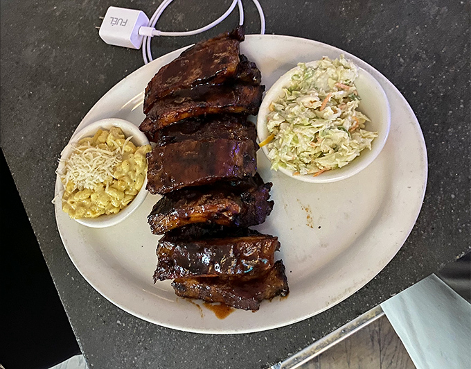 BBQ ribs so tender they practically surrender to your fork, flanked by mac and cheese and coleslaw like loyal sidekicks.