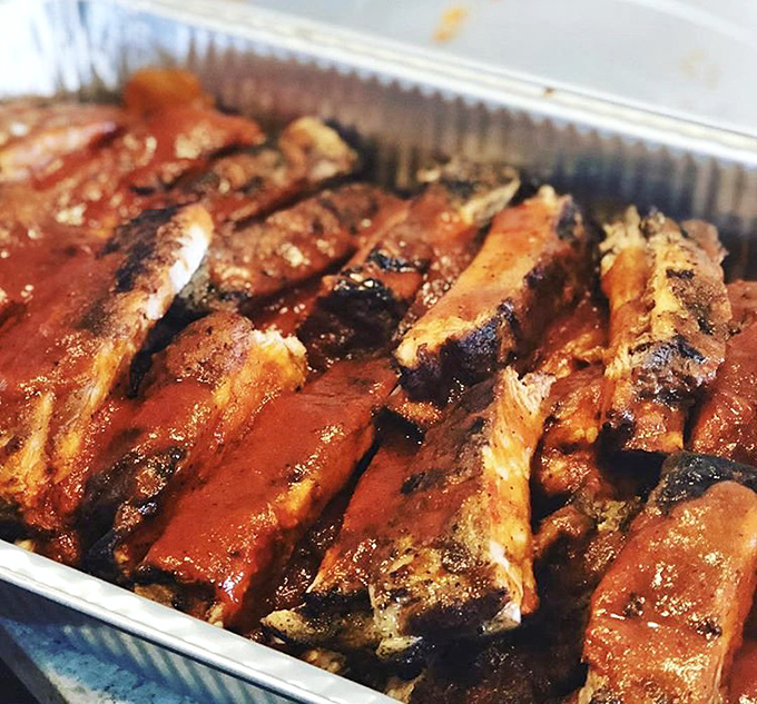 Ribs so tender they practically surrender to your fork, glistening with that signature sauce that walks the perfect sweet-heat tightrope.