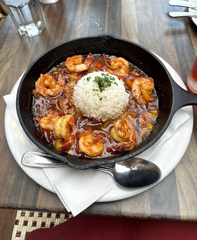 BBQ shrimp served in a cast iron skillet&mdash;because when food arrives still sizzling, you know you're in for a flavor concert.