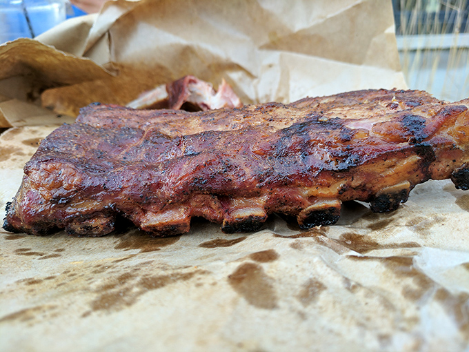 Barbecue architecture at its finest &ndash; these ribs showcase that perfect pink smoke ring beneath a bark that deserves its own fan club.