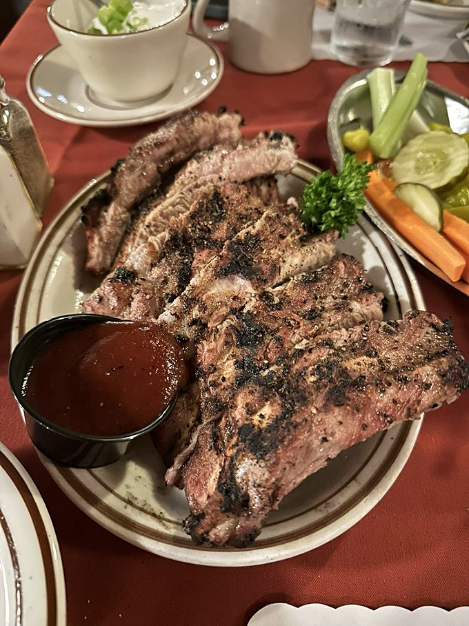 These ribs aren't falling off the bone—they're clinging to it with just enough resistance to remind you that proper barbecue requires a little work from your teeth.