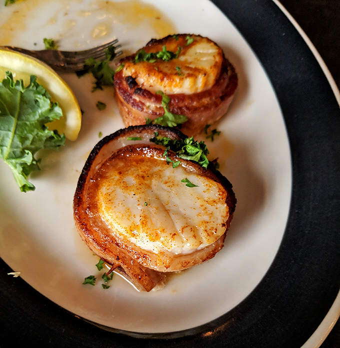 Bacon-wrapped scallops – where sea meets farm in perfect harmony. These little flavor bombs prove that sometimes the best things come in bacon packages.