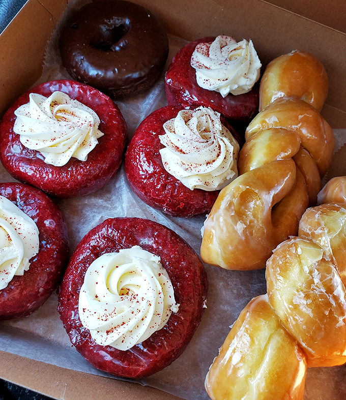 The box that makes friends instantly. One glimpse of these red-frosted donuts, and suddenly you're the most popular person at the office.