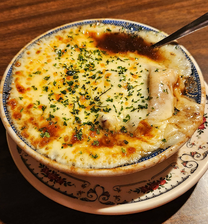 This isn't just onion soup&mdash;it's a bubbling cauldron of comfort, where cheese stretches like the stories of Paul Revere's ride.