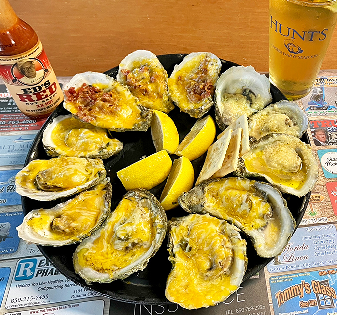 Baked oysters with cheese that create that perfect moment when the Gulf meets comfort food. The lemon wedges aren't just garnish&mdash;they're essential.