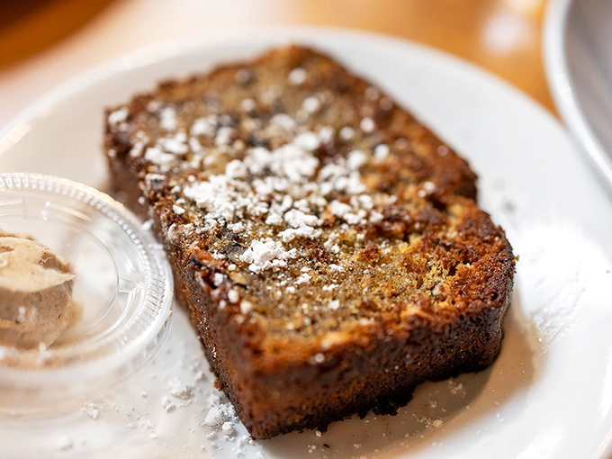 Golden-brown banana bread dusted with powdered sugar&mdash;proof that sometimes the simplest pleasures are worth crossing county lines for.
