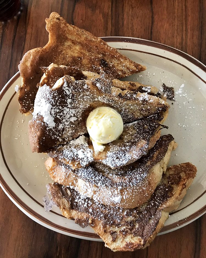French toast that makes you question all other breakfasts. Dusted with powdered sugar and topped with a dollop of butter, this is morning decadence defined.