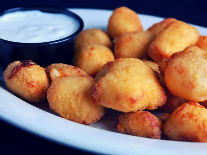 Wisconsin's unofficial state food—cheese curds—fried to golden perfection with that telltale squeak replaced by a satisfying crunch that would make any dairy farmer proud.