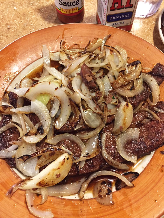 Caramelized onions dancing atop a perfectly seared steak&mdash;proof that simple ingredients in the right hands become extraordinary. This isn't just food; it's alchemy.