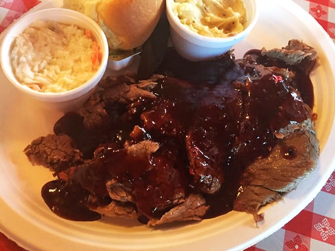 Brisket so tender it practically surrenders at the sight of your fork, wearing its sauce like a glossy badge of honor.