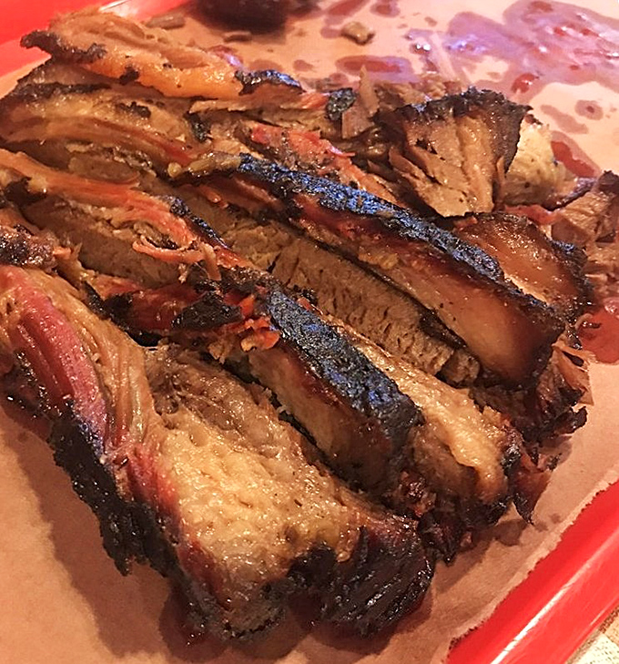 Sliced brisket with that telltale pink smoke ring and glistening bark&mdash;this isn't just meat, it's a diploma from Barbecue University.