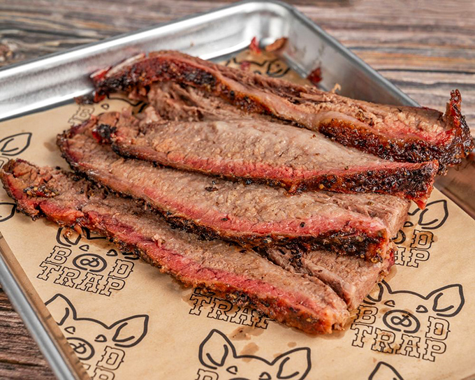 Brisket with that telltale smoke ring—nature's way of saying "patience rewarded." Each slice tells the story of hours well spent.