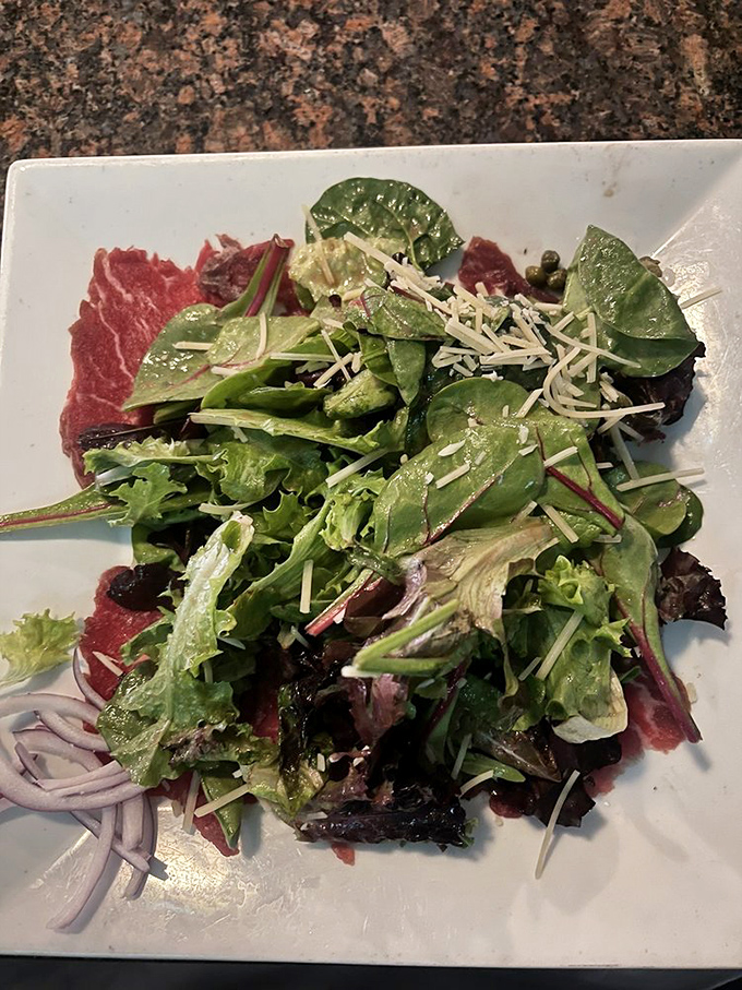 Fresh greens and shaved cheese create a simple salad that proves quality ingredients make all the difference.