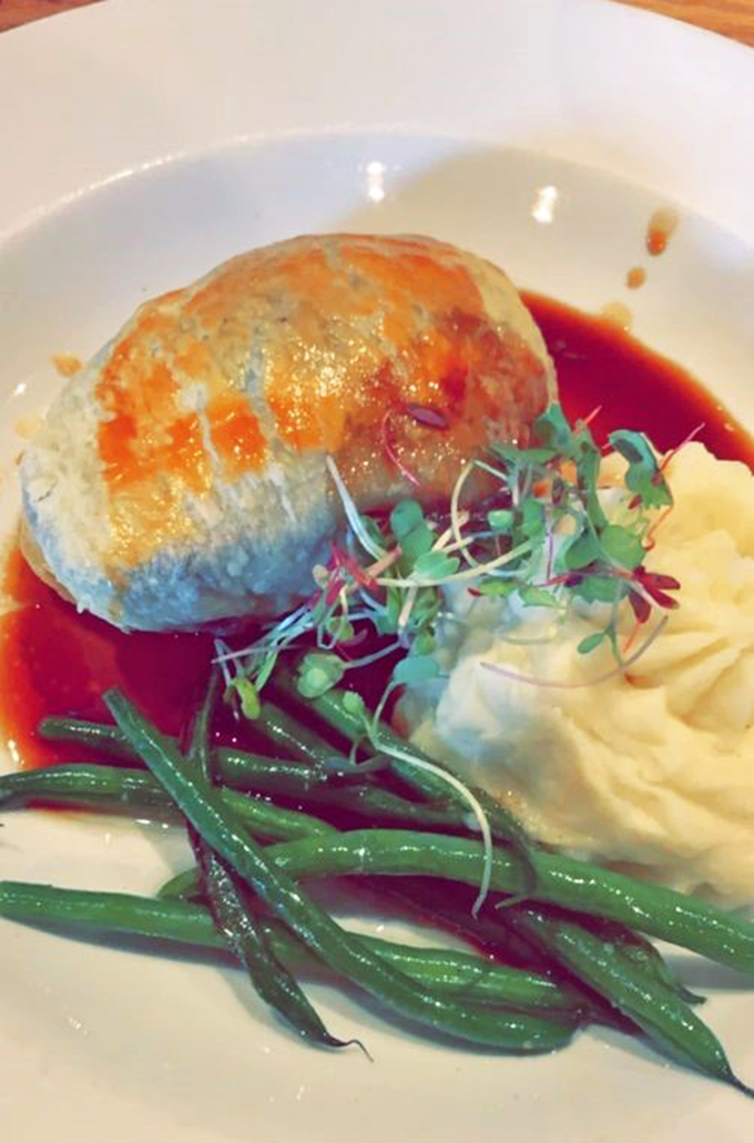 Not just dinner, but an event. This Wellington arrives like royalty, wrapped in golden pastry with a crown of rich gravy and a side of buttery mashed potatoes.