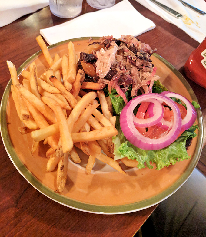 A plate that tells the story of patience – brisket with fries and sides that didn't rush to your table, but took the scenic route through flavor country.