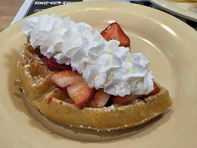 This Belgian waffle topped with strawberries and whipped cream isn't just breakfast &ndash; it's dessert with morning permission slip attached.