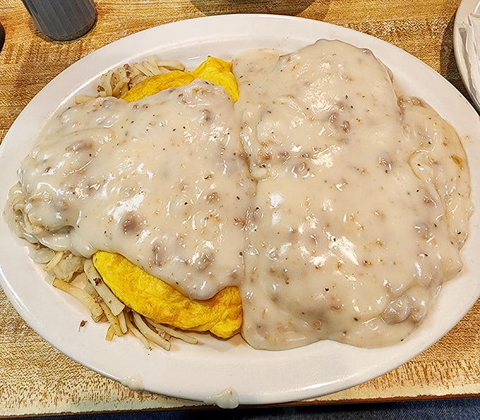 Biscuits smothered in creamy sausage gravy&mdash;a dish so comforting it should come with a pillow. Those hash browns underneath are the foundation this masterpiece deserves.