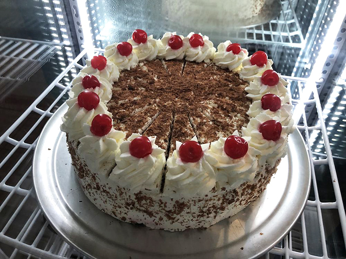 Black Forest cake that looks like it stepped straight out of a fairy tale. Those cherries perched atop whipped cream peaks are like edible rubies.