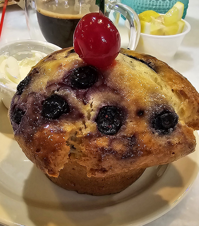 This blueberry muffin topped with a cherry isn't just baked goods&mdash;it's edible architecture with fruit jewels that would make any pastry chef proud.