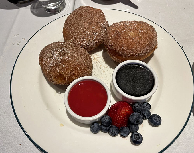 These bombolini aren't just donuts&mdash;they're sugar-dusted spheres of happiness served with dipping sauces and berries for good measure.