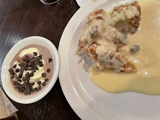 Bread pudding swimming in vanilla sauce alongside chocolate-topped pudding&mdash;proof that the best relationships are sweet, rich, and slightly indulgent.