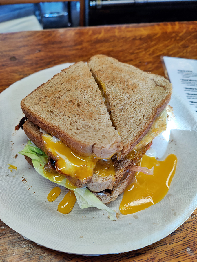 This breakfast sandwich isn't just leaking yolk&mdash;it's sharing joy. The kind of messy goodness that makes Monday mornings bearable.