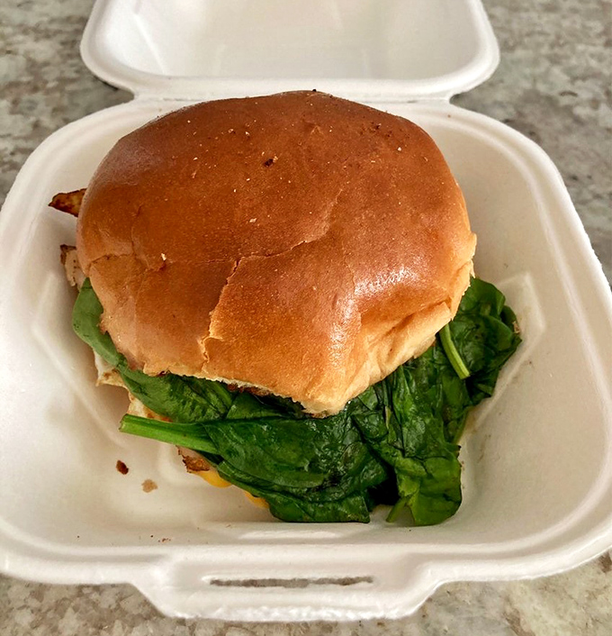 Proof that spinach can find happiness when sandwiched between a perfect bun and whatever delicious ingredients are hiding underneath.