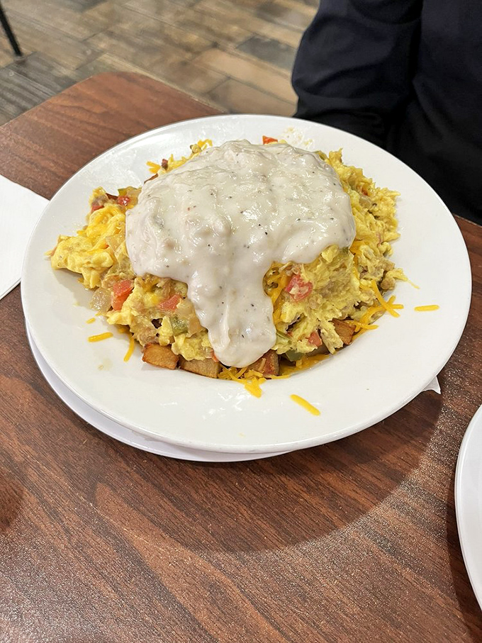 Breakfast scrambler that doesn't know the meaning of restraint. With gravy cascading down like a waterfall of comfort, this plate means business.