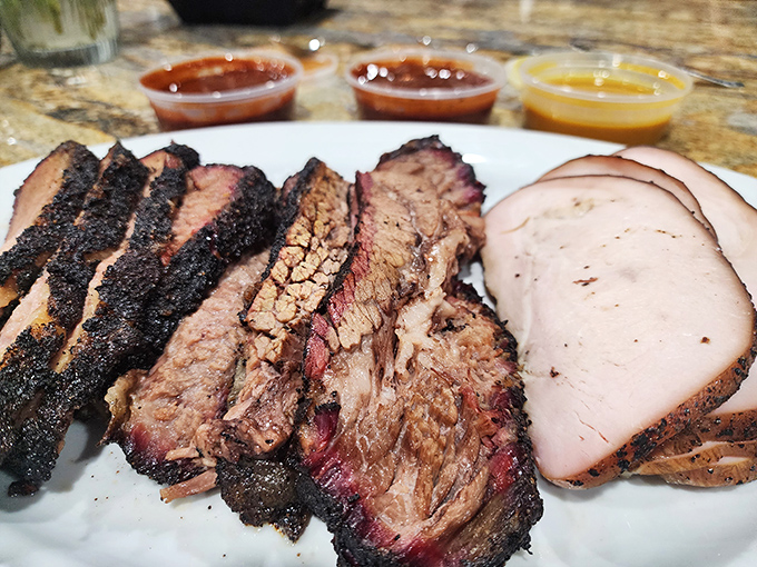 Brisket with that telltale pink smoke ring and turkey sliced thin&mdash;proof that patience and wood smoke create culinary magic.