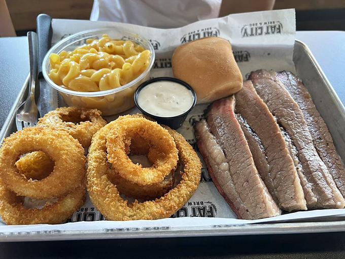 Brisket sliced to perfection alongside golden onion rings and mac and cheese. A tray of comfort that speaks directly to your soul.