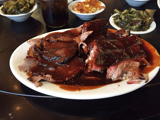Barbecue plated on a vibrant red dish&mdash;because even the plateware knows this is food worth celebrating. Meat candy for grown-ups.