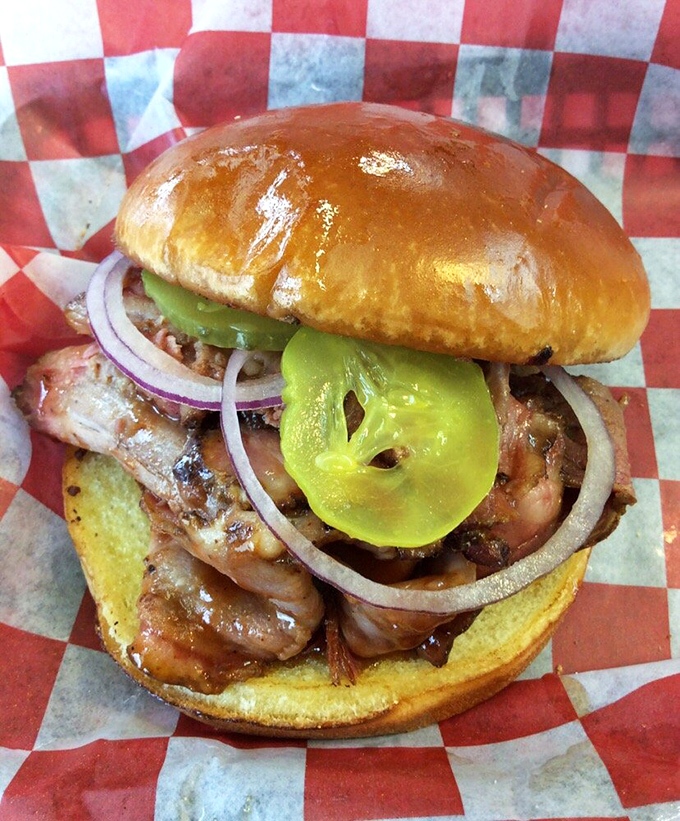 A sandwich that demands both hands and your full attention: barbecue brisket topped with pickles that cut through the richness perfectly.