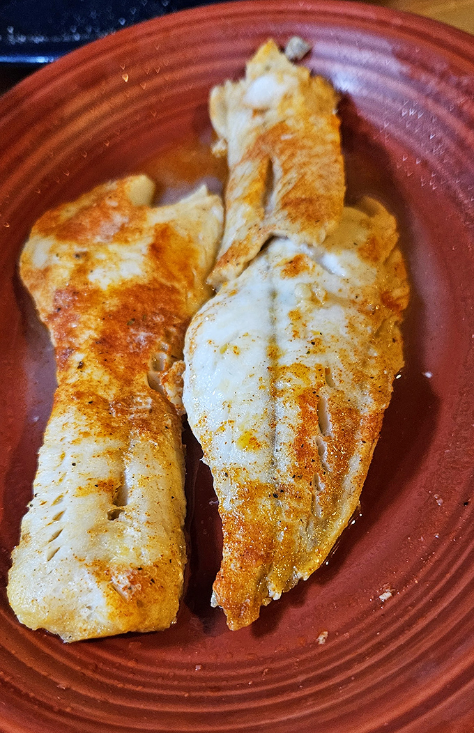 Broiled walleye that proves sometimes the simplest preparation lets the star ingredient shine. Lake-to-plate perfection on a rustic dish.