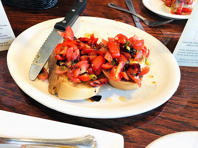 Bruschetta done right: a mountain of vibrant tomatoes on crusty bread. It's summer captured on a plate, regardless of the season outside.