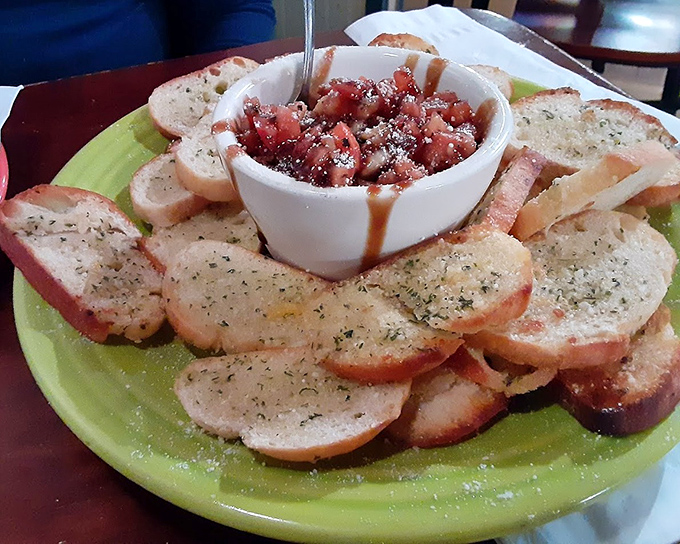 Bruschetta that demands to be photographed before eaten. Toasted bread circles the star attraction: fresh tomatoes drizzled with balsamic that dance on your taste buds.