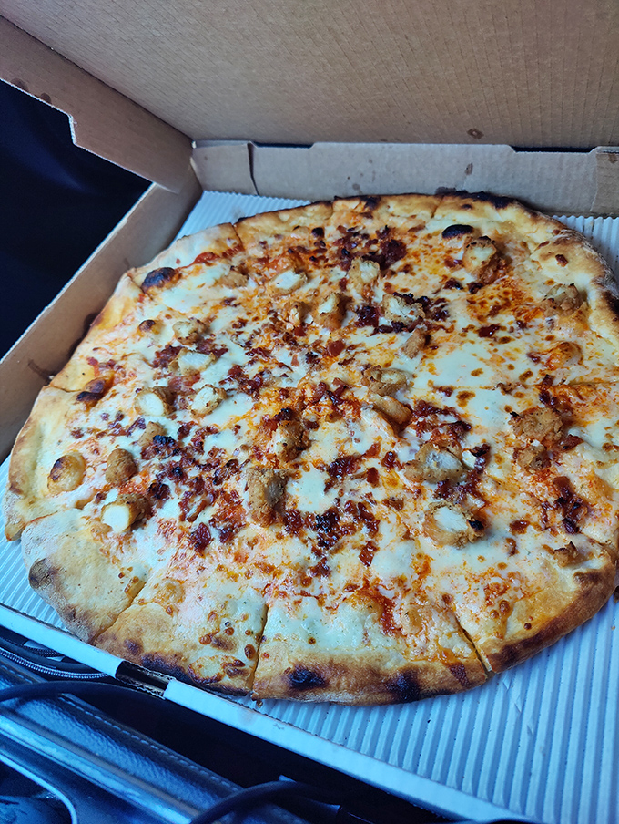 Buffalo chicken pizza that brings the heat and the sweet, with that signature orange sauce drizzle that'll have you licking your fingers shamelessly.
