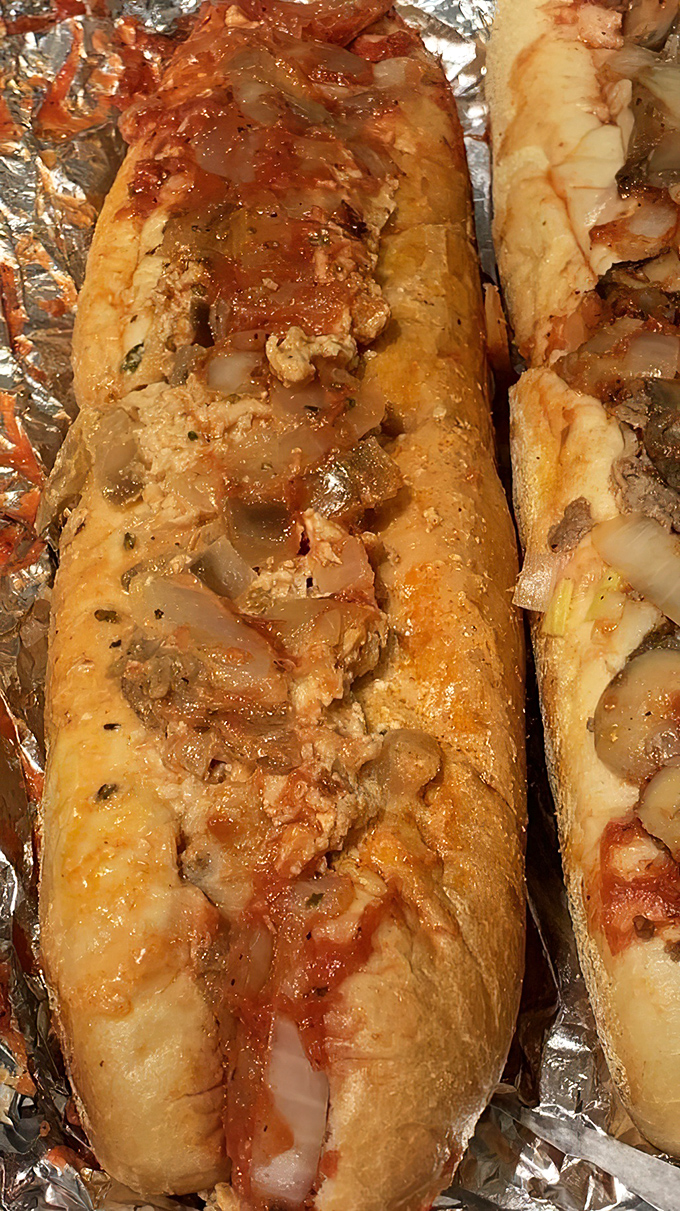 Cheesesteaks wrapped in foil like the precious gifts they are. The glistening onions and sauce create a symphony of flavors that Philly would approve.