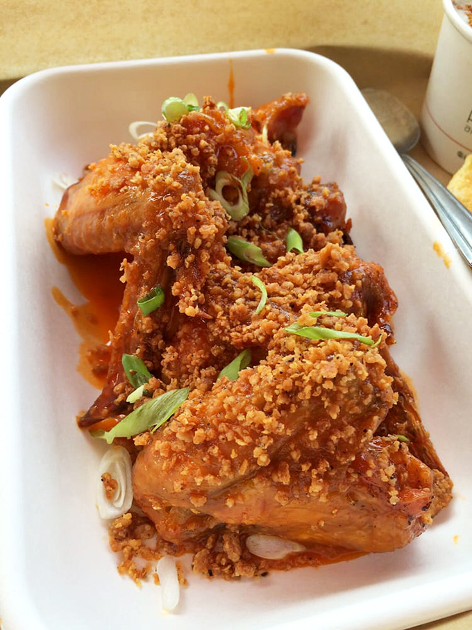 Crispy wings glistening with sauce and topped with fresh scallions&mdash;proof that sometimes the messiest foods are life's greatest pleasures.