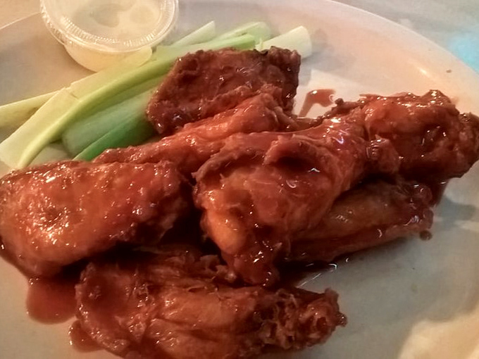 Buffalo wings that don't mess around&mdash;crispy, saucy, and unapologetically messy, with celery sticks offering the illusion of healthful balance.