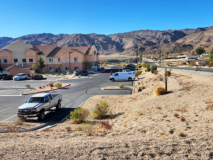 Modern housing developments nestle against rugged mountains, offering retirement living with nature's most dramatic backdrop as your daily view.