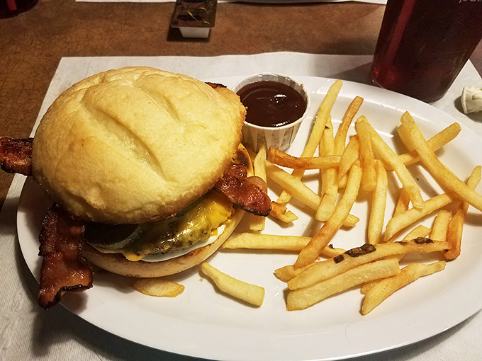A burger that demands a two-handed commitment and possibly a post-meal nap. Those golden fries are the supporting actors who steal the show.